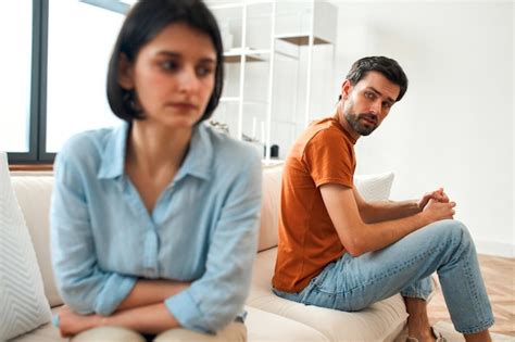 Premium Photo Unhappy Sad Couple Sitting Apart On Couch In Living