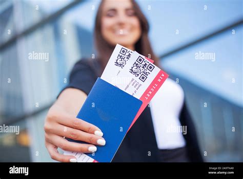 Travel Closeup Of Girl Holding Passports And Boarding Pass At Airport