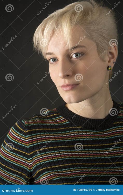 Serious Head And Shoulders Portrait Of Young Blonde Woman Stock Image