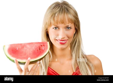 Cute Blond Girl In Red Dress And Red Lips Eating A Water Melon Stock