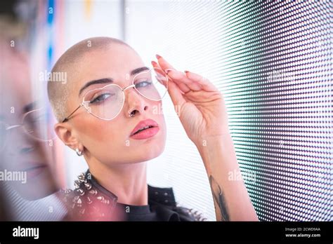 Image Of A Beautiful Young Woman Posing Against A Led Panel Shaved