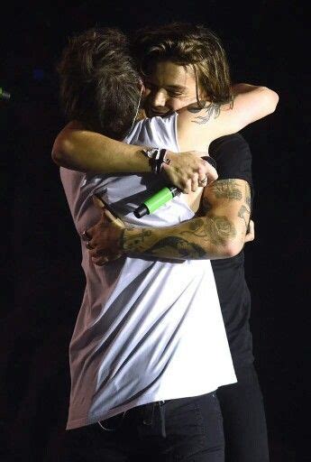 Two People Hugging Each Other While One Person Has His Arm Around The Other
