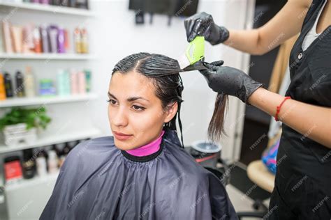 Premium Photo The Hairdresser Applies Professional Liquid Keratin To