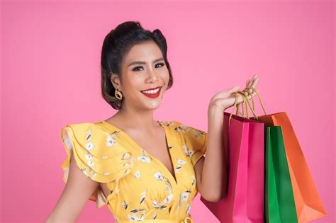 Free Photo Beautiful Asian Woman Holding Colored Shopping Bags