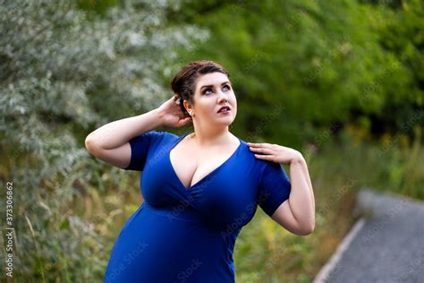 Sexy Plus Size Fashion Model In Blue Dress With A Deep Neckline