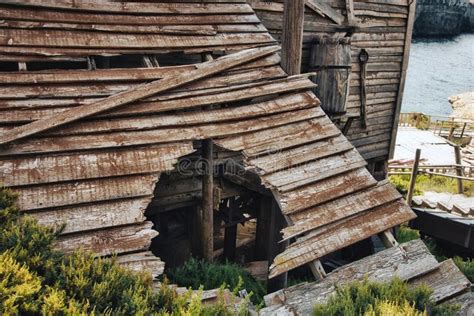 A Gaping Hole In The Roof Of A Wooden Barn Or Hut In A State Of