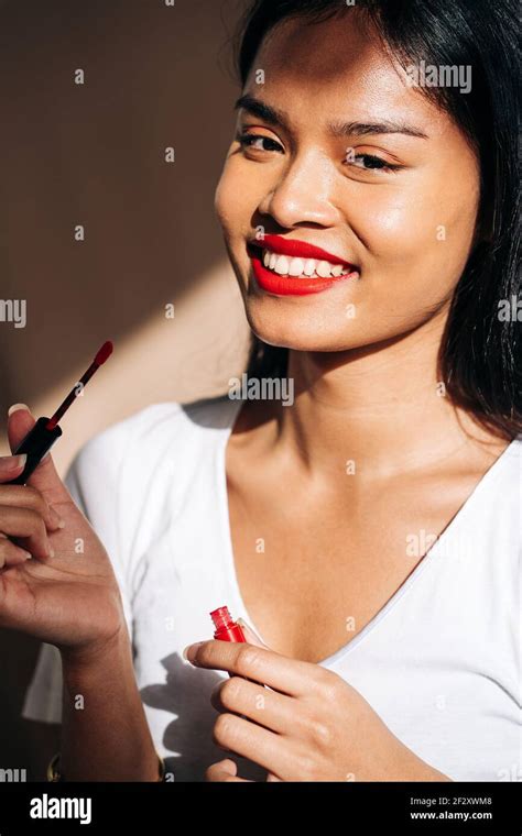 Portrait Of Cheerful Ethnic Female With Long Dark Hair Looking At