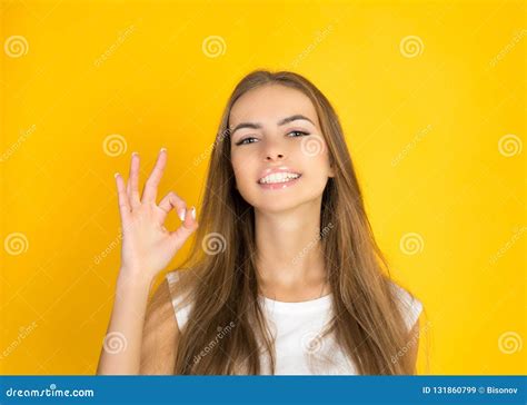 Portrait Of A Happy Young Blonde Girl Showing Ok Gesture Stock Image