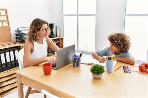 Mother And Son Drawing And Using Laptop Working At Office Stock Image