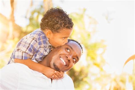Mixed Race Son And African American Father Playing Outdoors Together