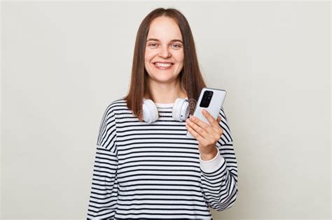 Attractive Smiling Brown Haired Adult Woman Wearing Striped Shirt