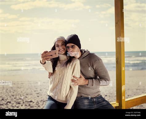 Very Happy Couple In Love Taking Selfie On The Beach In Autmun Day