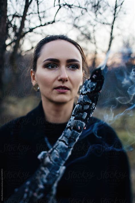 Woman With Charred Smoldered Branch By Stocksy Contributor Liliya