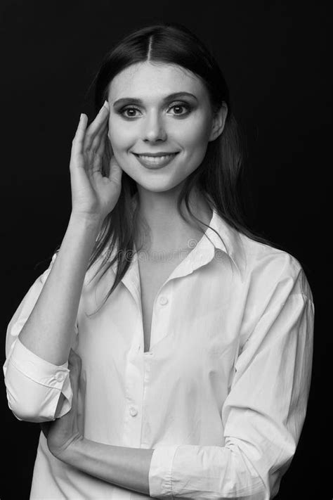 Black And White Portrait Of A Beautiful Woman In A White Shirt On A