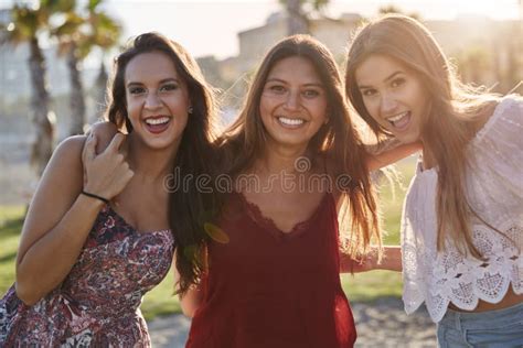 Three Pretty Girls Standing Together In Sunlight Smiling Stock Image