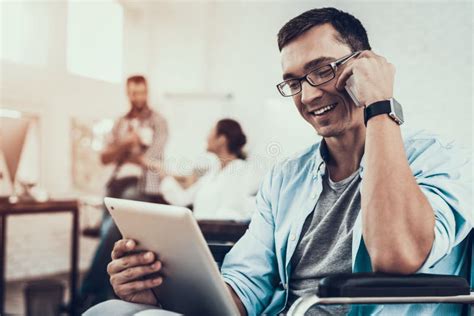 Man In Glasses On Wheelchair With Tablet In Office Stock Image Image