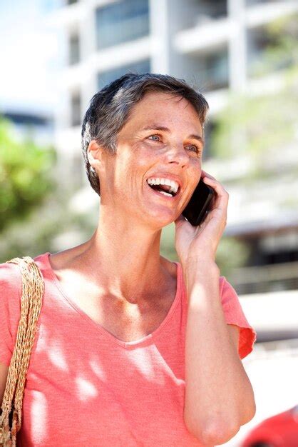 Premium Photo Happy Mature Woman Talking On Mobile Phone Outdoors