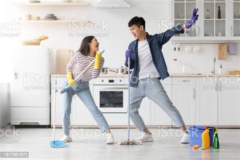 Funny Asian Couple Singing Songs While Cleaning Kitchen Copy Space