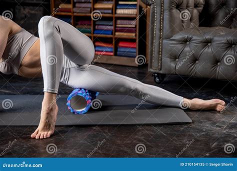 Young Pretty Woman Doing Stretching Exercises At Home She Sits On A