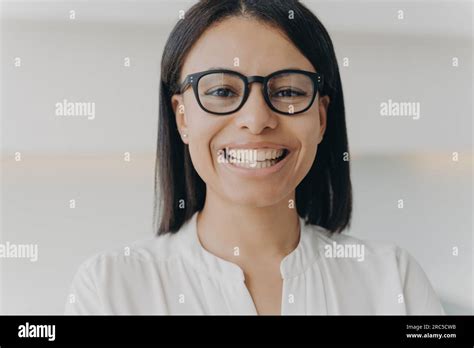 Happy Businesswoman In Glasses Smiles Looking At The Camera With A