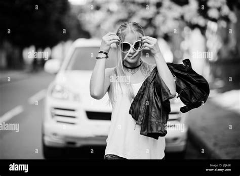 Stylish Blonde Woman Wear At Jeans Sunglasses Choker And White Shirt
