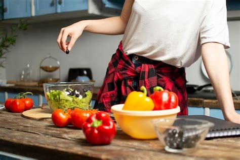 Premium Photo Young Girl Prepares A Vegetarian Salad In The Kitchen