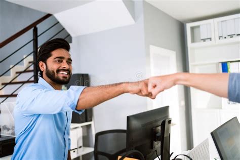 Cheerful Indian Businessman Partners Making Fist Bump With A Smile As A