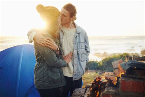 Kisses At Dawn An Affectionate Young Couple Kissing At Sunrise At