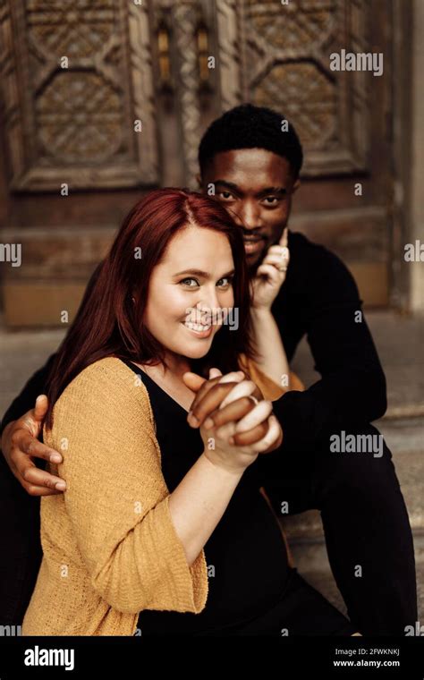 Portrait Of Adorable Couple Cuddle Near The House Walking At The City