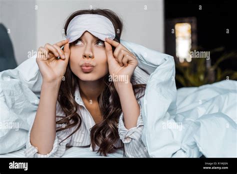 Beautiful Brunette Girl With Sleeping Mask On Head Looking Up Stock