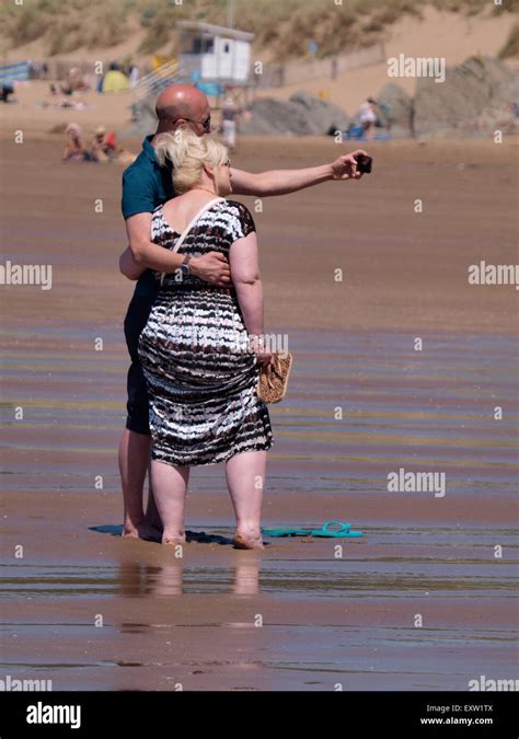 Middle Aged Couple Taking A Selfie At The Beach Woolacombe Devon Uk