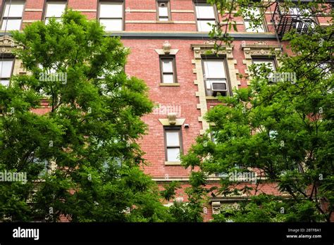 Typical New York City Brick Apartment Building In Spring Surrounded By