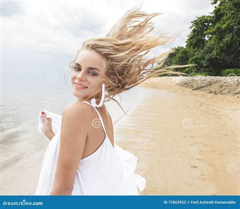 Beautiful Woman Enjoying Summer On The Beach And Wind Blow Her H Stock