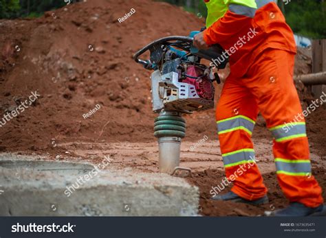 Image result for Indian Man Using Soil Compaction Machine