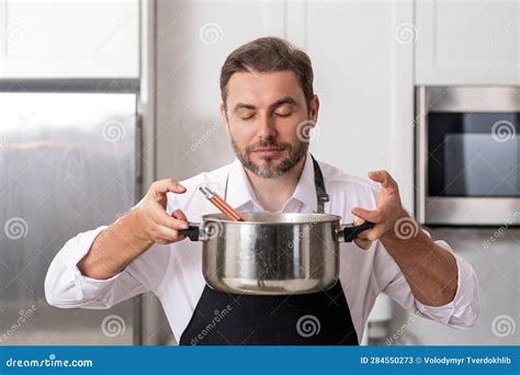 Man Cooking at Kitchen. Handsome Man Preparing Delicious Meal in Modepn ...