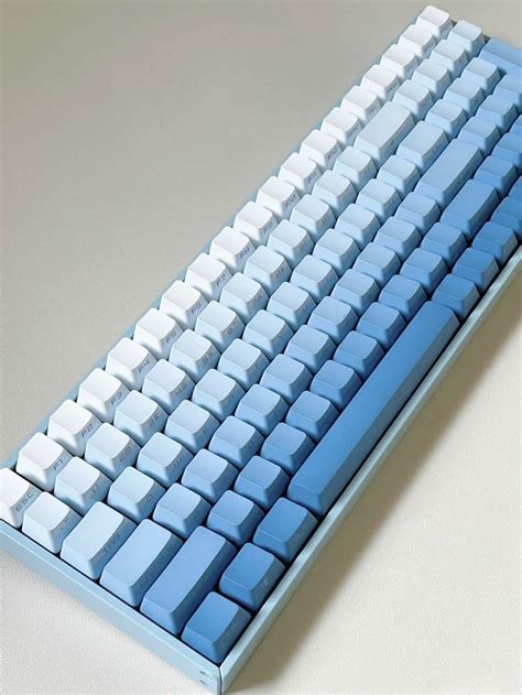 a blue and white keyboard sitting on top of a table