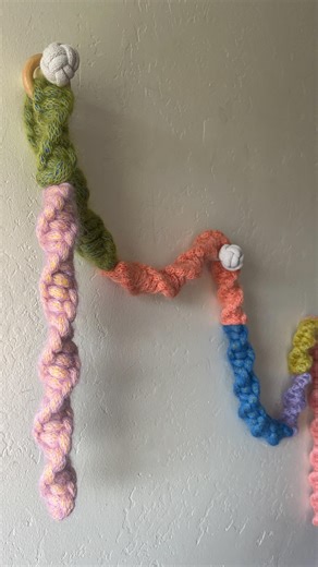 Sitoë Thiam on Instagram: "i wish i'd counted how many skeins of mohair this project took all the cord you see is knit with a tiny hand crank i-cord machine, layered with 2-3 colors, then knotted into rope 🪢 i used some light woodshop skills to make the three pegs. did y'all know i used to help manage my school's machine shop back in college? #fiberartist #macrame"