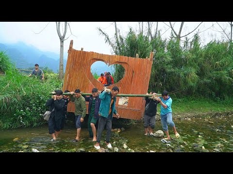 KONG NHAT, with the help of his neighbors, successfully transported the enormous shack.
