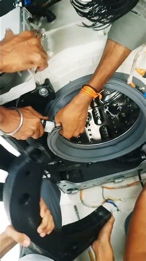 front-loading washing machine, likely an LG model, undergoing repair. 