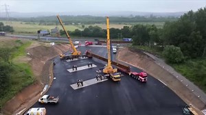 Network Rail reveals drone footage of two 42-metre beams being delivered to the M62 worksite ahead o