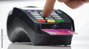 Credit card payment terminal, swiping for sale transaction. Close-up view.