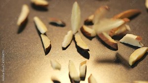 Almonds sliced falling in slow motion. Close-up of almonds sliced