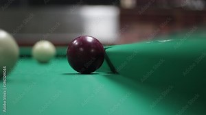 Game of billiards. White billiard balls roll on the table. Sports entertainment in the bar. Simple background with a pool table. Balls hitting and moving.