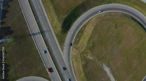 Aerial above modern multilevel road junction epic highway green grass. Rotation freeway. Active movement of transport cars vehicles in different directions. Driving logistics delivery Russia Europe.