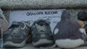 Close up of the BC Legislative Assembly buildings with a memorial for Indigenous Children victims on the front steps in Victoria BC, showing children's shoes and a note.