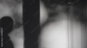 Shadow of boy outlined on gray wall dance of light and darkness playful light-shadow interplay boy form distinctly visible. Boy shadow vividly displayed on gray wall merging reality and illusion