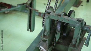 Traditional Thai textile manufacture in craft village, Old women work on weaving thread machines