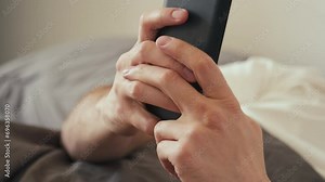 Stab closeup of removing phone from charger and continuing using it while in bed at homeStab closeup of removing phone from charger and continuing using it while in bed at home