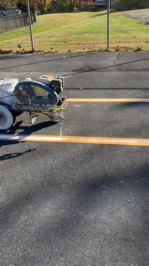 Our crew painting Tennis Lines by taping them out for the best results | Davis Line Striping & Sealcoating