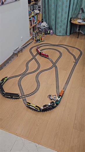 Three LEGO trains and a sudden derailment on a multi-track layout